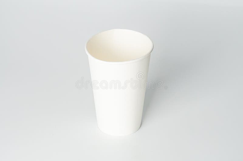 A Single White Ridged Paper Cup Slightly Off-center on a Light ...