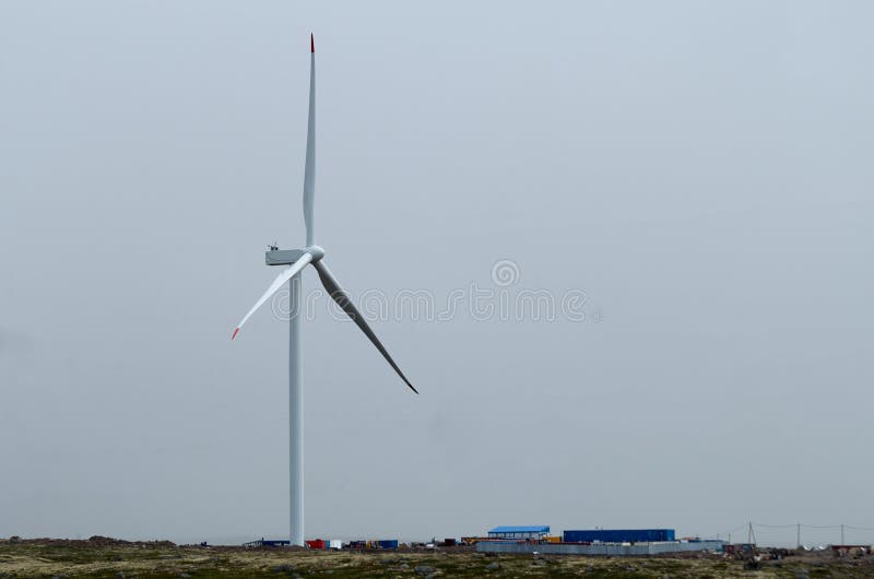Single Wind Turbine Against the Sky and Outbuildings Stock Photo ...