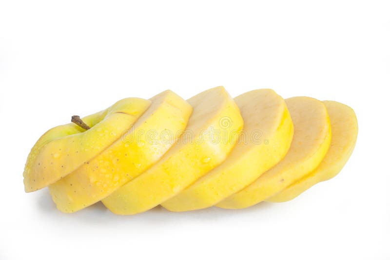 Single Yellow Apple Cut into Diagonal Slices Stock Photo - Image of ...
