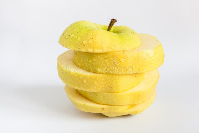 Single Yellow Apple Cut into Horizontal Slices Stock Photo - Image of ...
