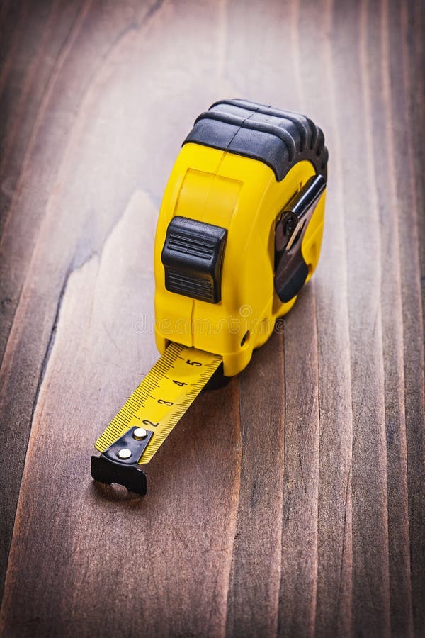 Single Yellow Tapeline on Vintage Wooden Board Stock Photo - Image of ...