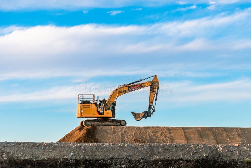 Cat Yellow Heavy Machinery Excavator Digger on a Road Construction Site ...