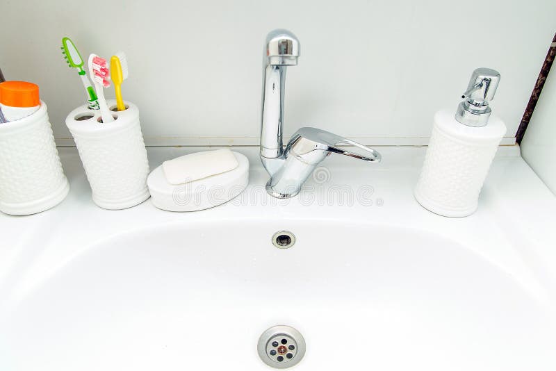 Sink,toothbrushes and Liquid Soap in the Bathroom Stock Image - Image ...