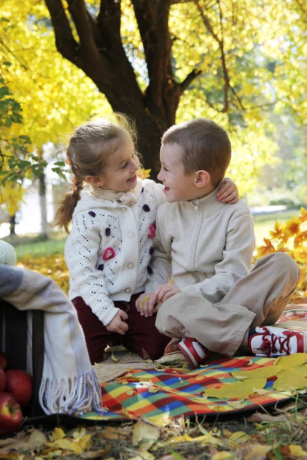 Sister and Brother Talking Friendly Under Autumn Tree Stock Photo ...