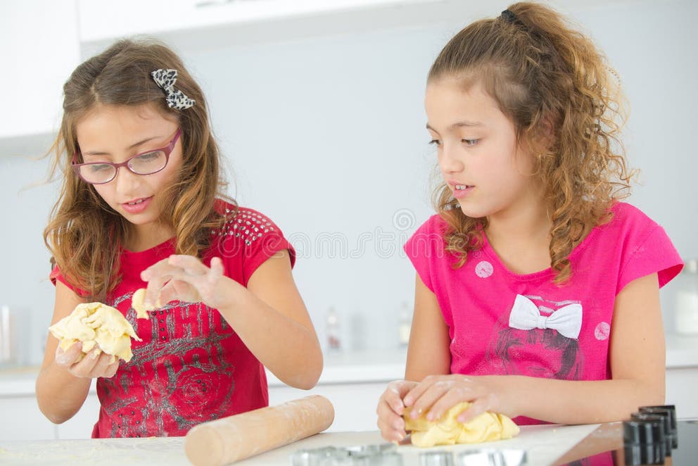 Sisters baking in kitchen stock image. Image of childhood - 89110511