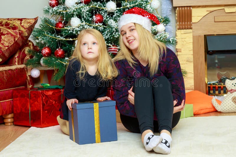 2 Sisters by the Christmas Tree. Stock Image - Image of little ...