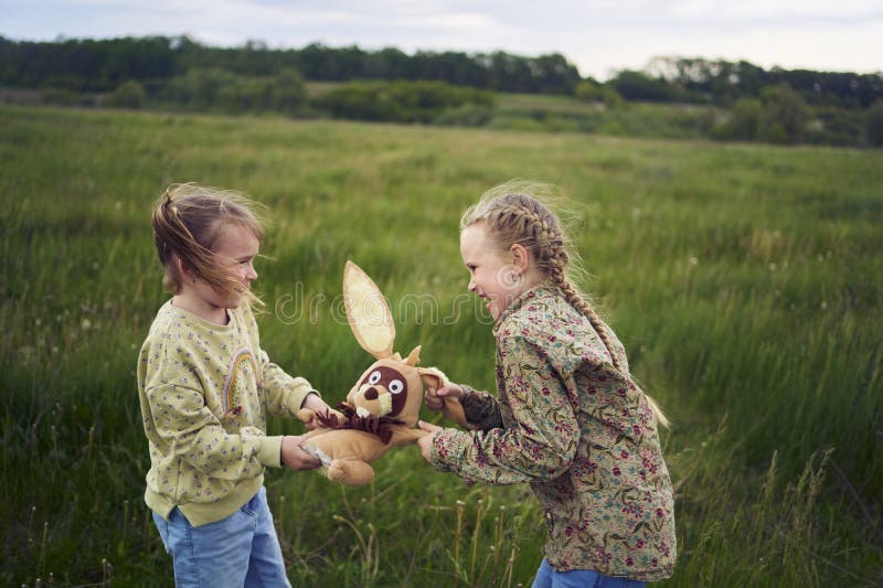 Sisters Fight Over a Toy Bunny Stock Photo - Image of bully, dispute ...