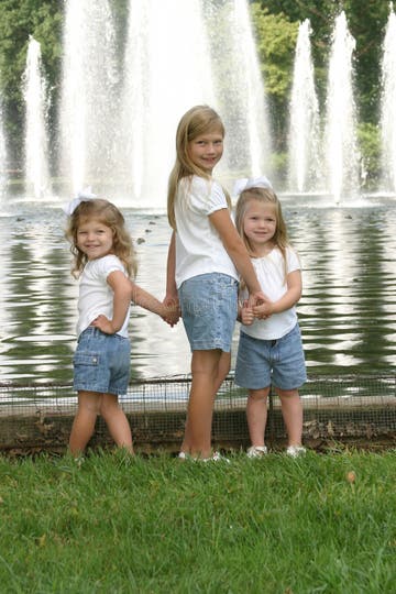 Sisters holding hands stock photo. Image of family, gazing - 216970