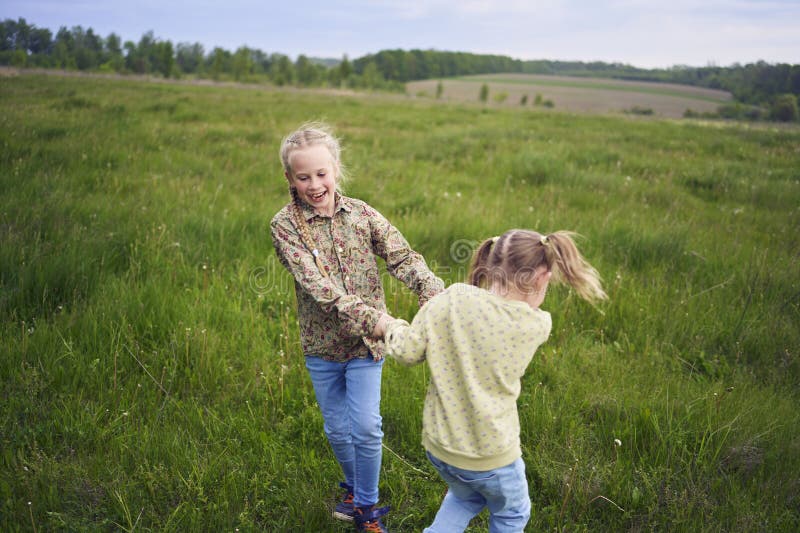 Sisters Hug and Protect Each Other from the Wind in the Field Stock ...