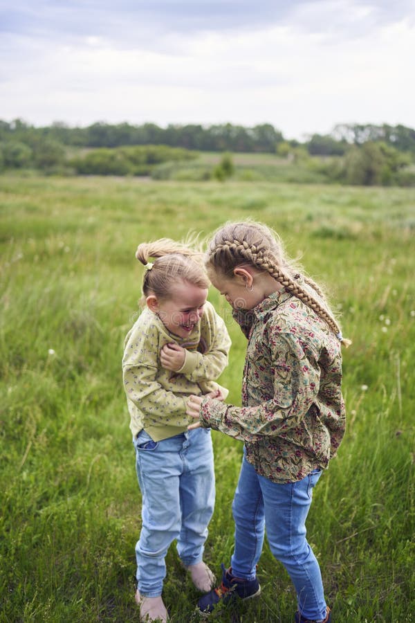 Sisters Hug and Protect Each Other from the Wind in the Field Stock ...