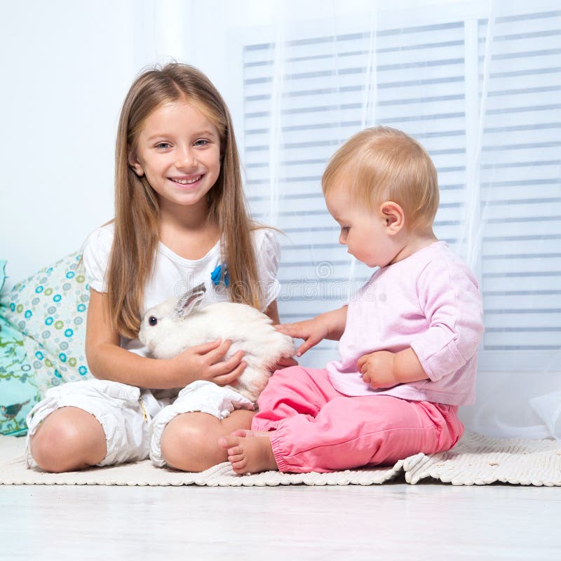 Sisters with a rabbit stock image. Image of happiness - 33996969