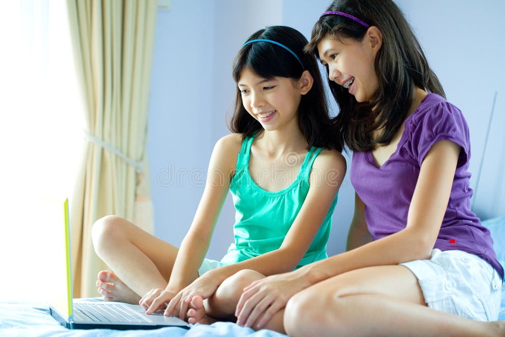 Sisters Sharing a Laptop in Home Environment Stock Image - Image of ...