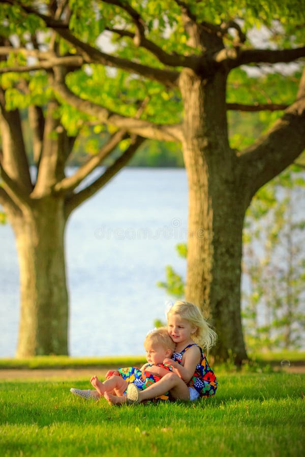 Sisters sitting outside stock image. Image of springtime - 73098039