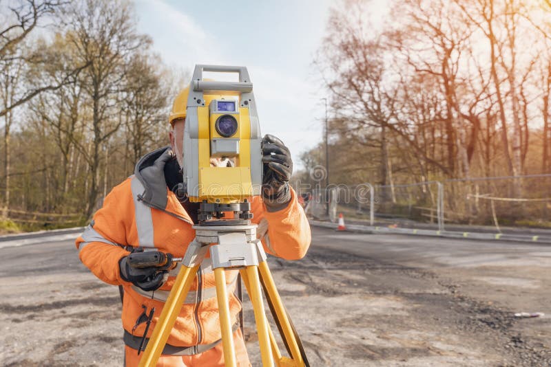 Site Engineer Operating His Instrument during Roadworks. Builder Using ...