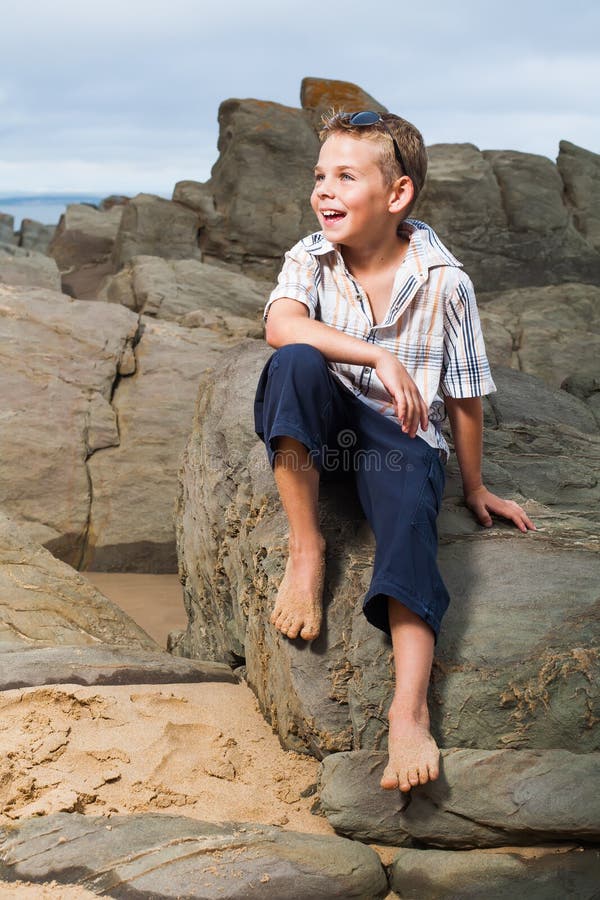 Sittig on the rocks stock photo. Image of coast, caucasian - 29291342