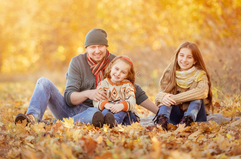 Sitting in autumn leaves stock image. Image of cheerful - 162843247