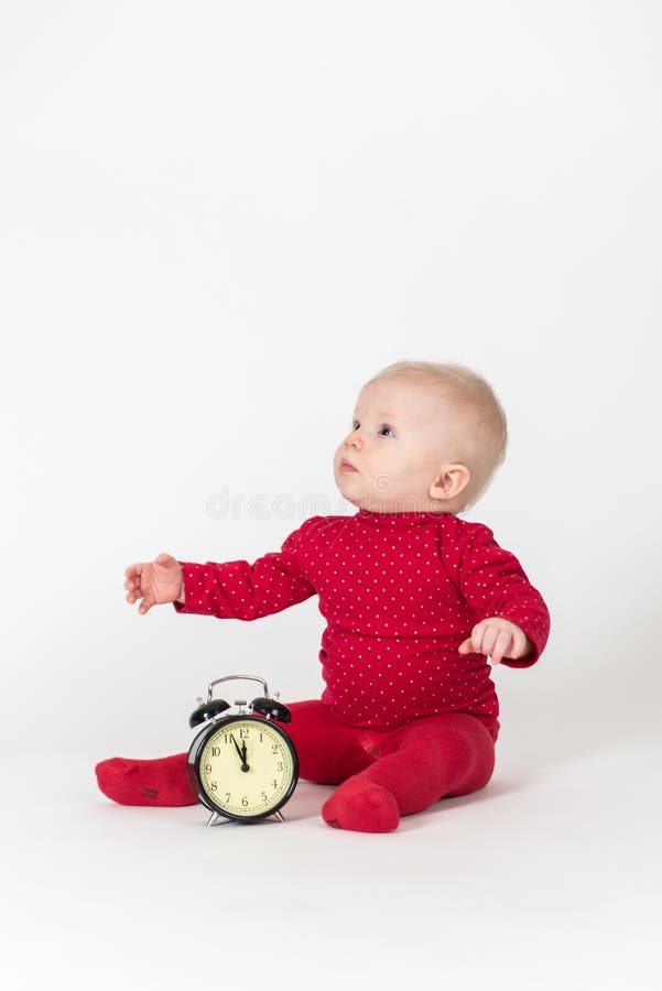 Sitting Baby with Clock in Red Suite Stock Image - Image of female ...