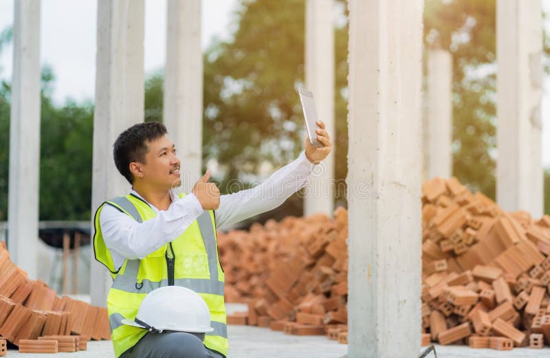 Engineer Sitting at Construction Project Holding Tablet Selfie Chatting ...