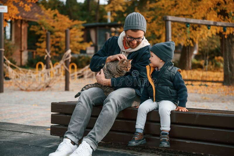 Sitting with Cute Cat. Father and Young Son is Together Outdoors at ...
