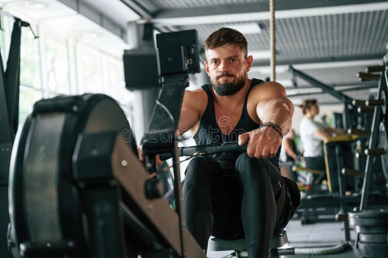 Sitting, Doing Stamina Exercise. Strong Muscular Man is Working Out in ...