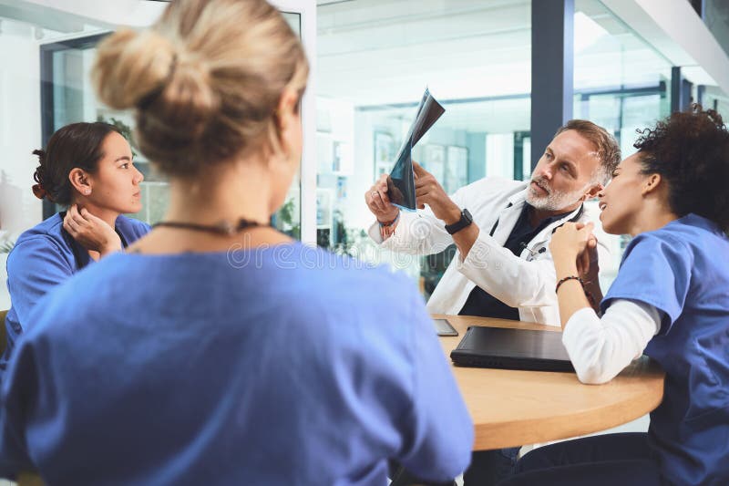 Sitting Down for Some Medical Problem Solving. a Team of Doctors ...