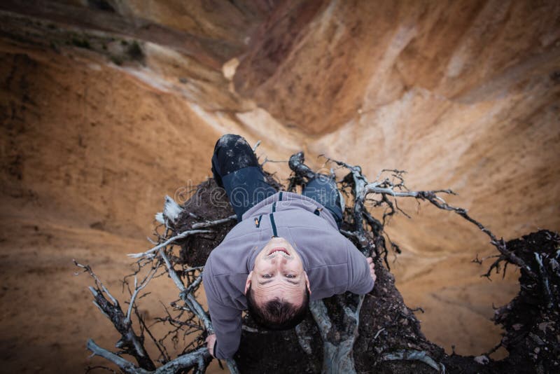 Sitting on the Edge of a Cliff Stock Image - Image of extreme, mountain ...