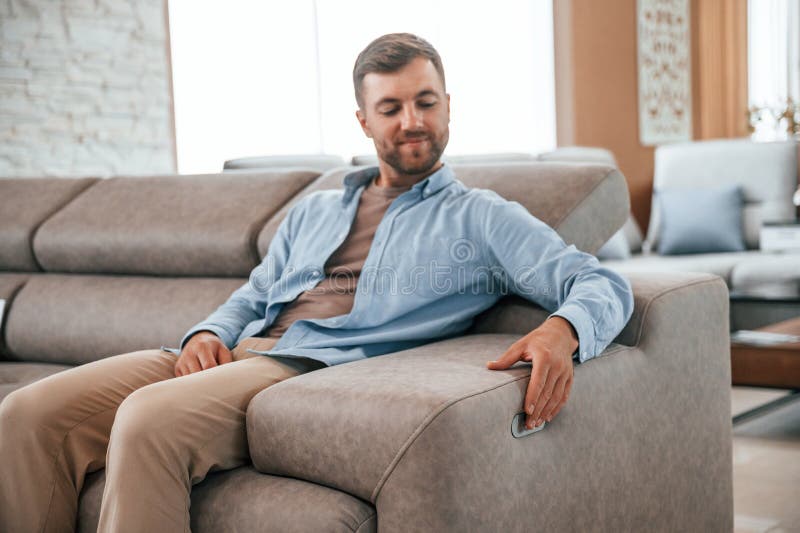 Sitting and Enjoying. Customer Visiting the Sofa and Bed Store Stock ...