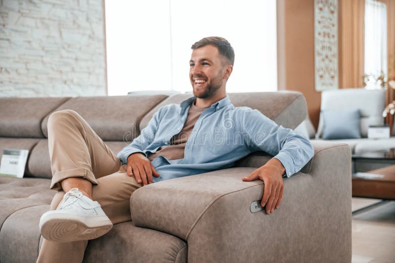 Sitting and Enjoying. Customer Visiting the Sofa and Bed Store Stock ...