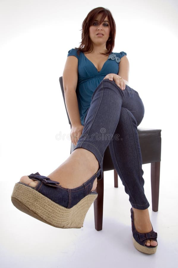 Young Woman Sitting on Chair with a Laptop and Cel Stock Photo - Image ...