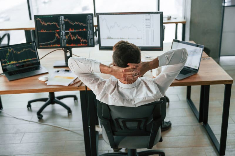Sitting with Hands Behind the Head. Businessman is by Computer and ...
