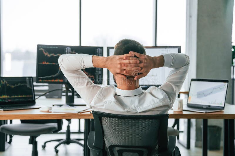 Sitting with Hands Behind the Head. Businessman is by Computer and ...