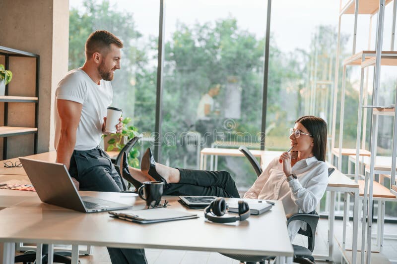 Sitting with Legs on the Table. Man and Woman are Working in the Modern ...