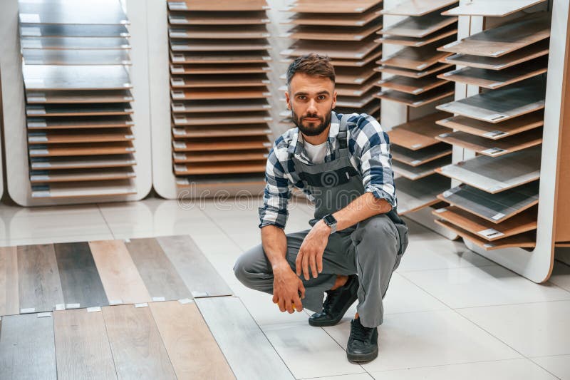 Sitting and Looking into Camera. Man in Grey Uniform is with Parquet ...