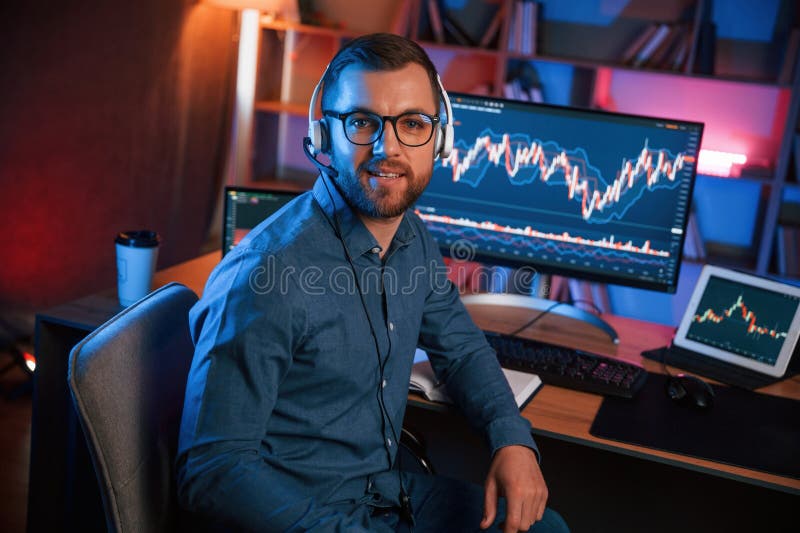 Sitting and Looking at the Camera. Stock Trader is Working by Pc ...