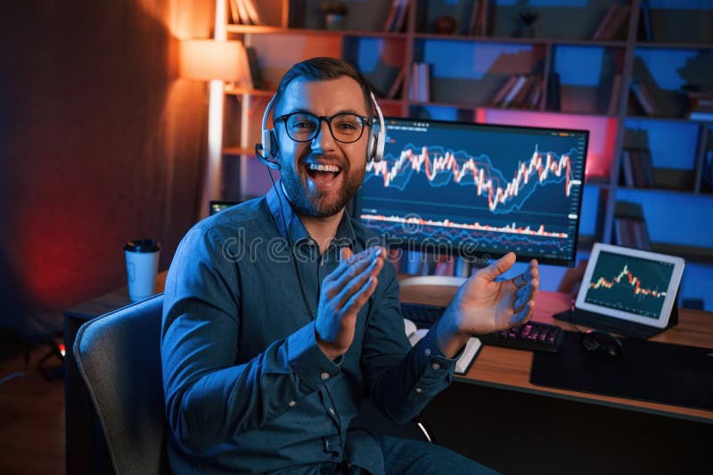 Sitting and Looking at the Camera. Stock Trader is Working by Pc ...