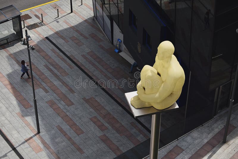 Sitting Man Statue Placed On Gray Metal Post Picture. Image: 111545634