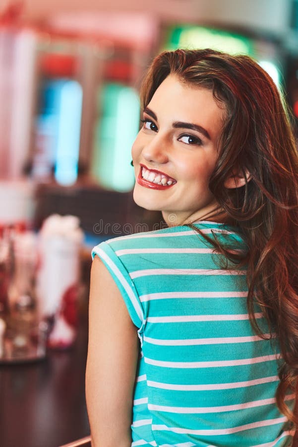 Sitting Pretty by the Diner. a Beautiful Young Woman in a Diner. Stock ...