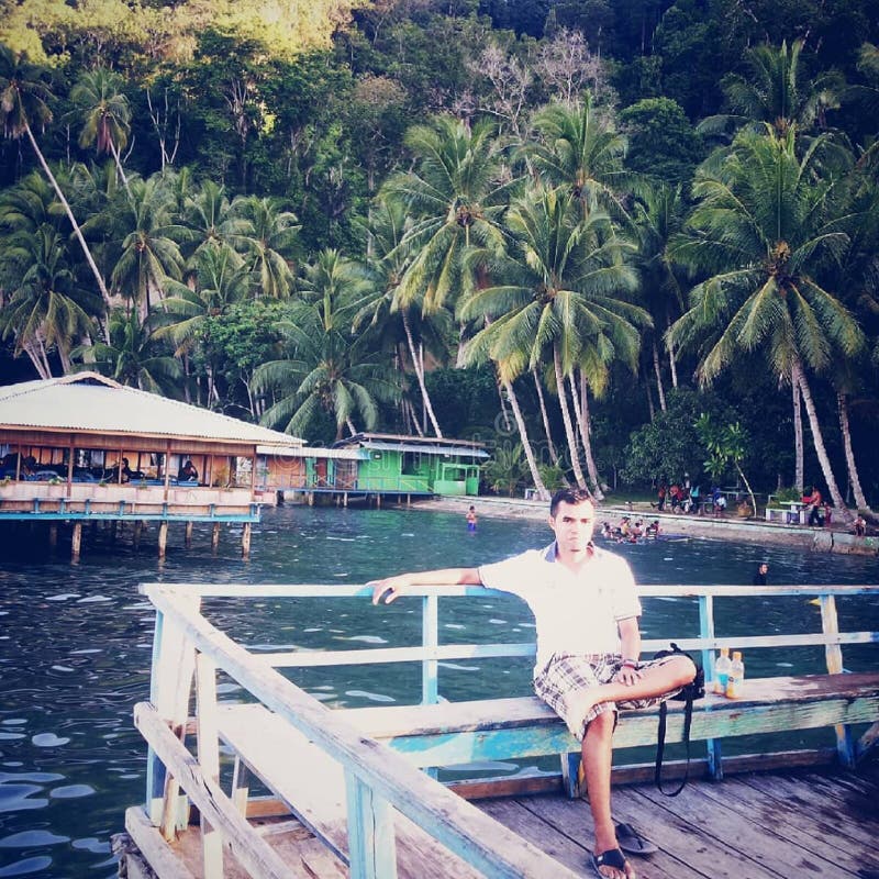 Bacan - North Moluccas: Sitting Relaxed on the Blue Pier Stock Photo ...