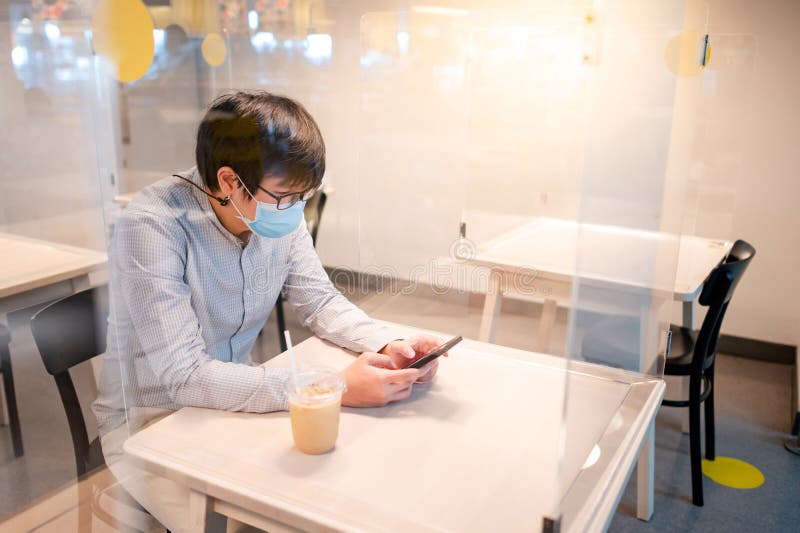 Sitting in Shield Partition for Social Distancing Stock Photo - Image ...