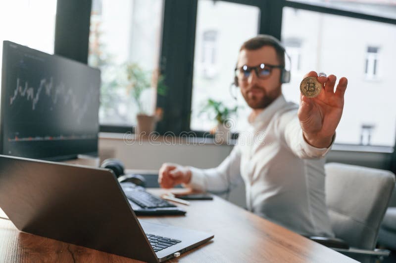 Sitting and Showing Physical Bitcoin. Man in Formal Clothes is Working ...