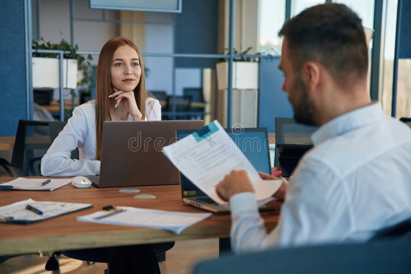 Sitting by the Table. Man and Woman Employees are Working in the Office ...