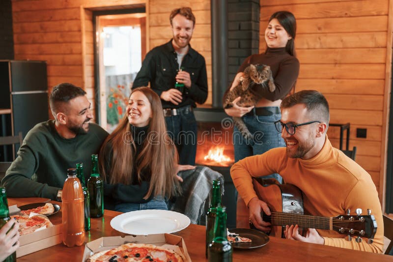 Sitting by the Table with Pizza and Beer. Group of Friends is Having ...