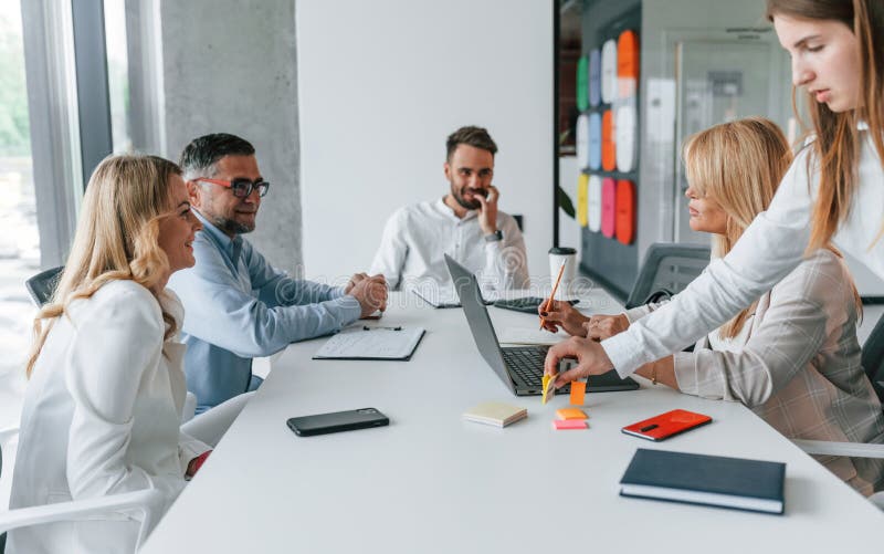 Sitting by the Table Together and Having a Conversation. Group of ...