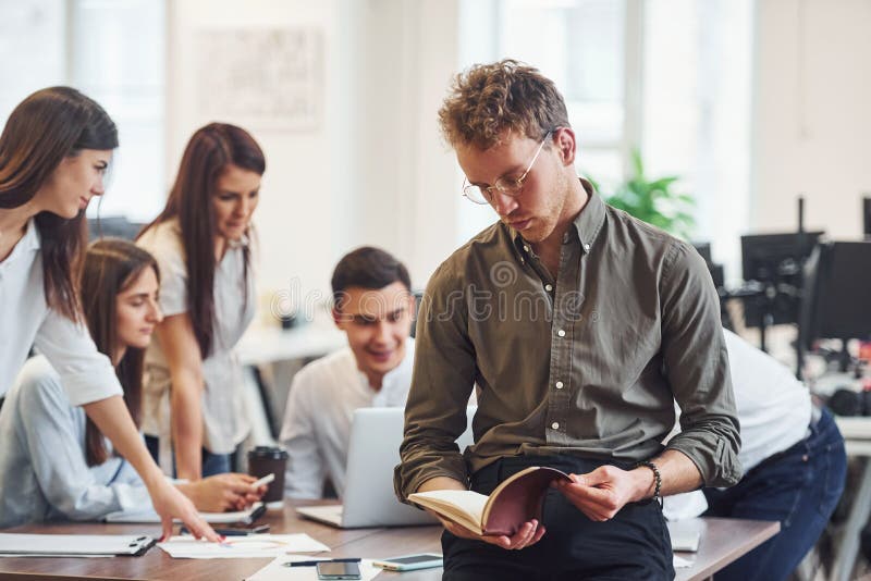 Sitting by the Table. Young Business People Working Together in the ...