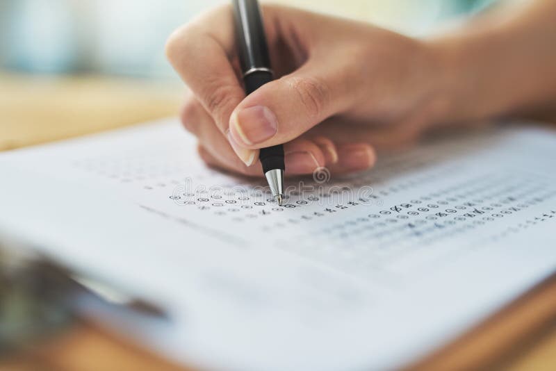 Sitting for a Test. a Woman Filling in an Answer Sheet for a Test ...