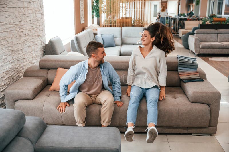 Sitting and Testing Product. Couple Choosing the Sofa and Bed in the ...