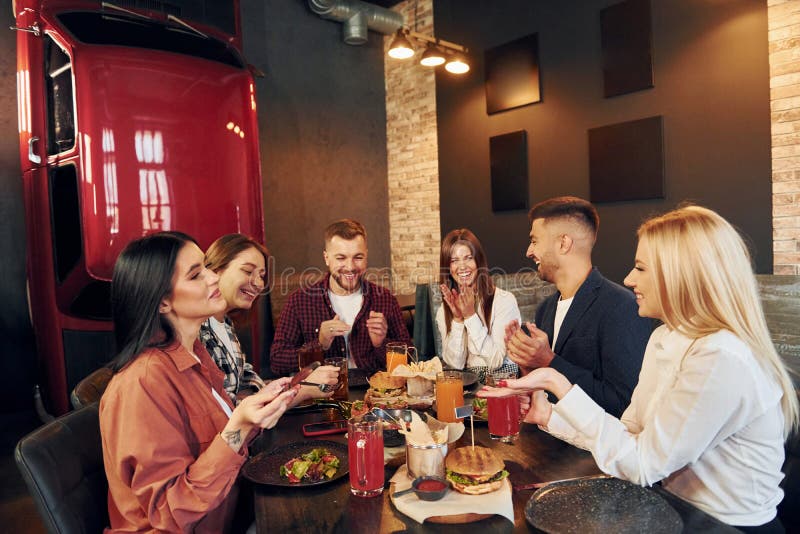 Sitting Together. Group of Young Friends in Bar with Beer Stock Photo ...