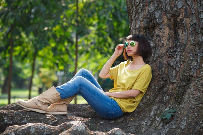 Sitting under the tree stock photo. Image of sunglasses - 51953732