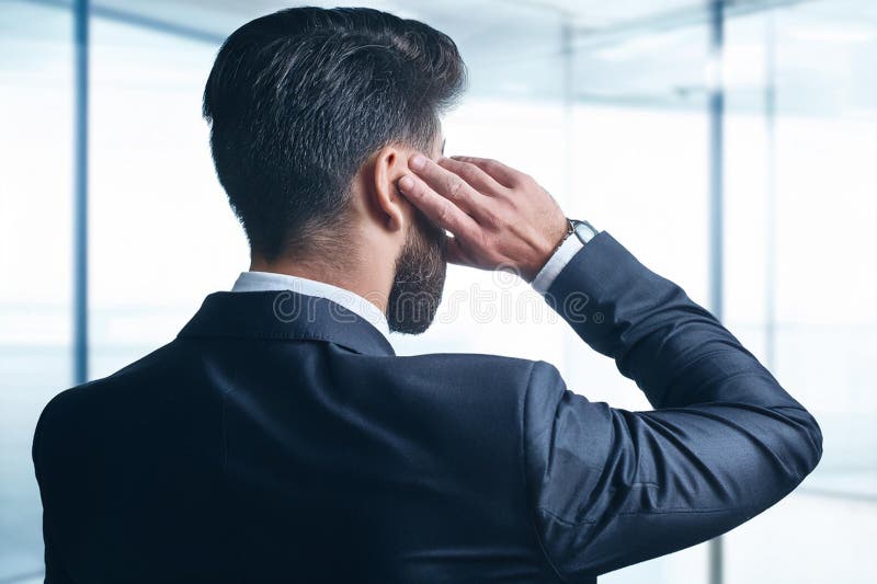 Generated Image Scene of a Man in a Suit Holding His Head Down at Work ...