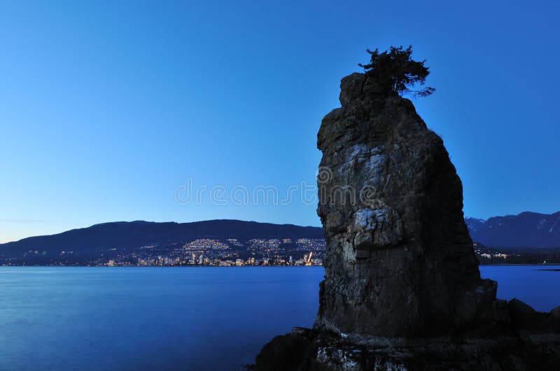 Siwash Rock in Stanley Park Stock Photo - Image of stanley, twilight ...